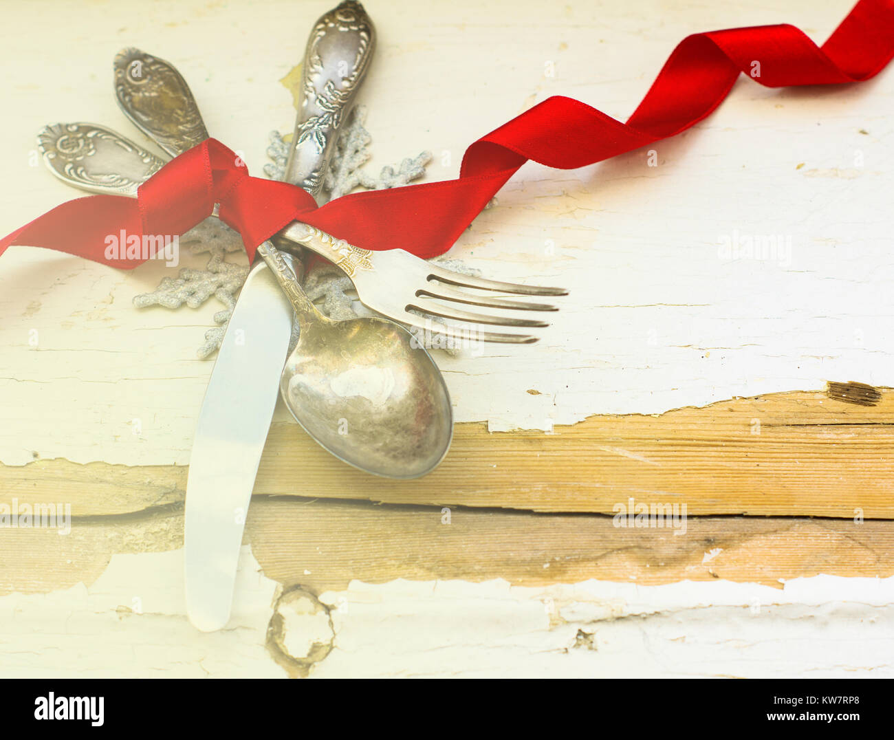 Vintage silverware with red ribbn on rustic background Stock Photo - Alamy