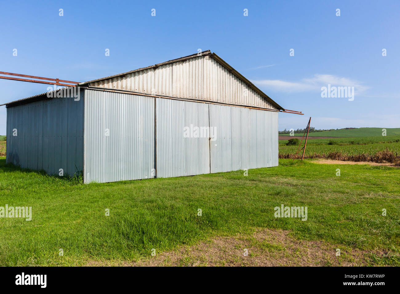 Grass airstrip aircraft plane outside hangar in rural farm countryside ...