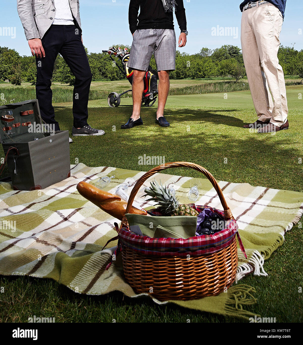 Three men on a picnic in a park Stock Photo - Alamy