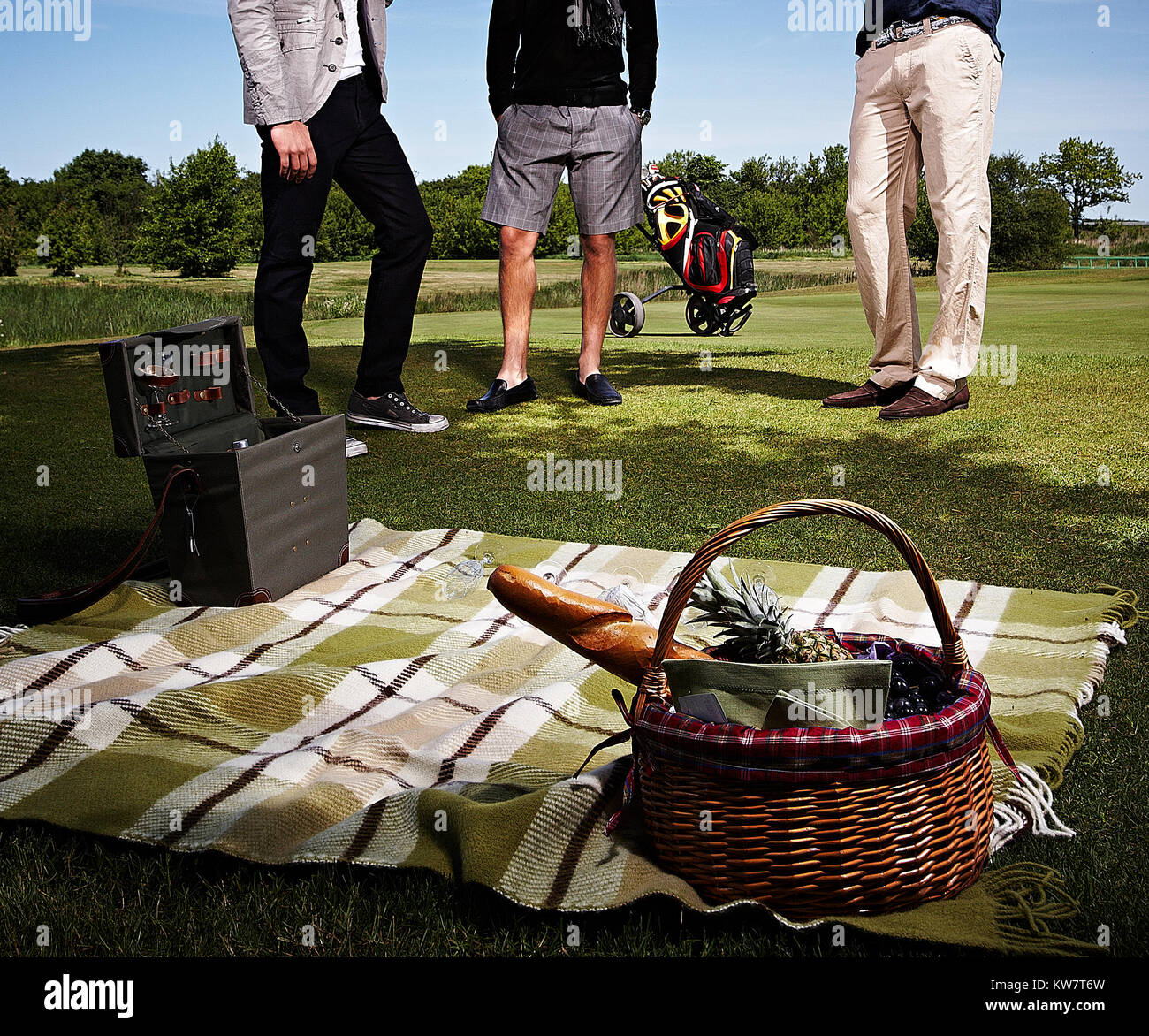 Three men on a picnic in a park Stock Photo - Alamy