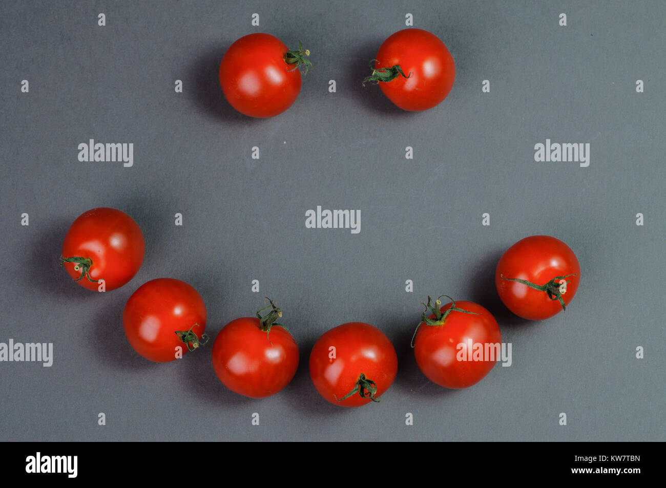 A face from red tomatoes Stock Photo - Alamy