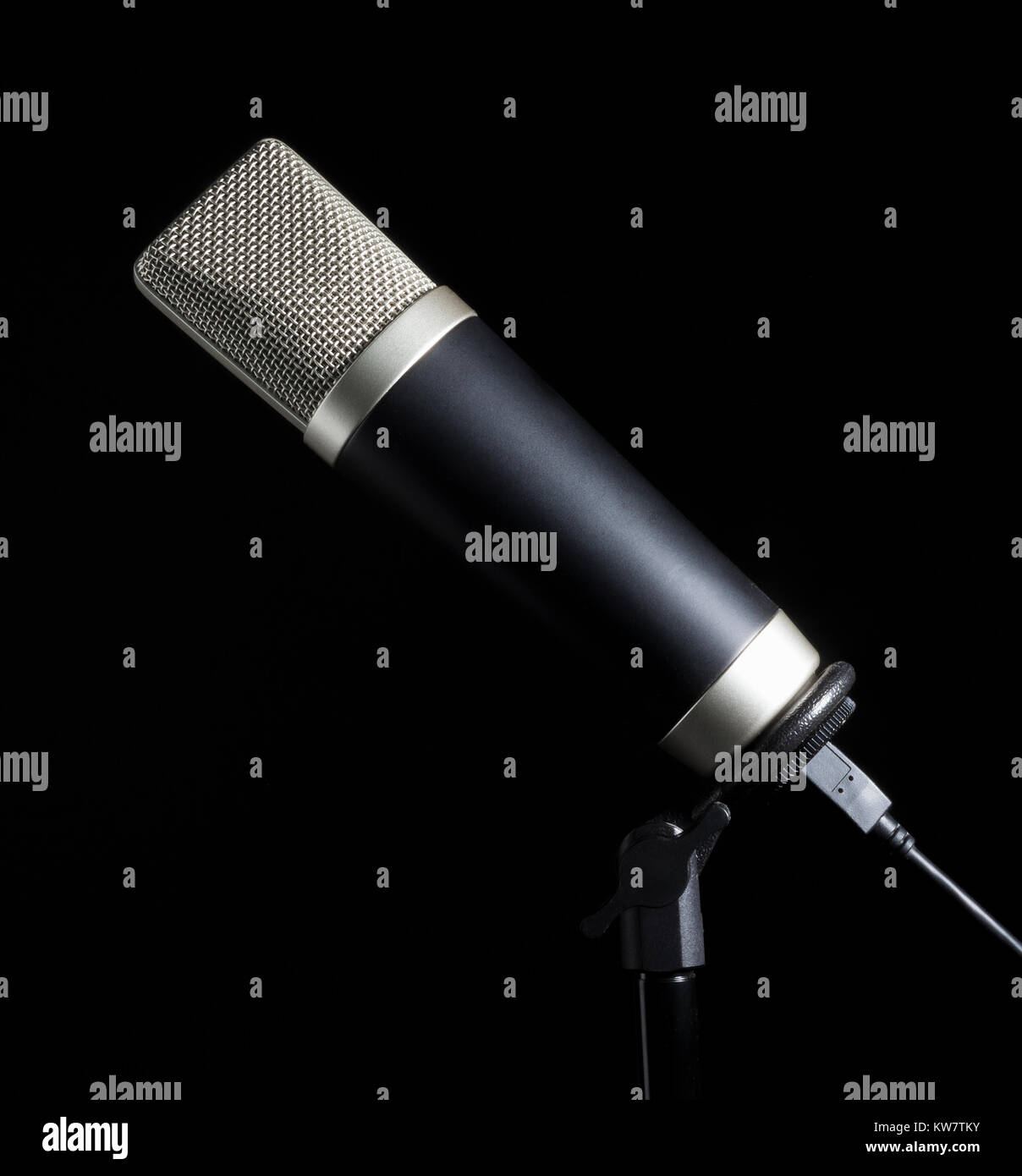 Microphone with wire mesh in its stand with a black background Stock ...