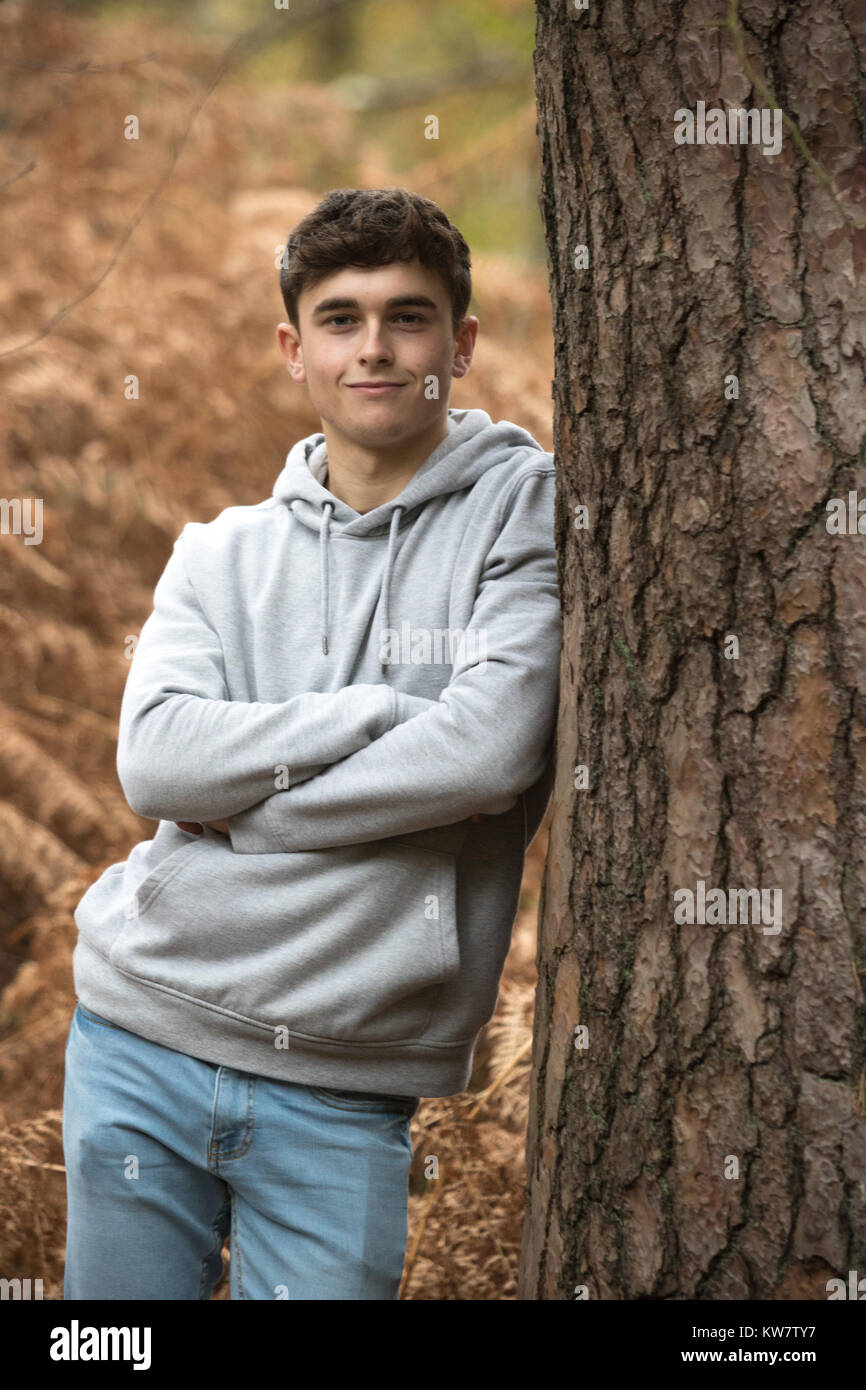 Caucasian Boy Leaning Against Tree High Resolution Stock Photography ...