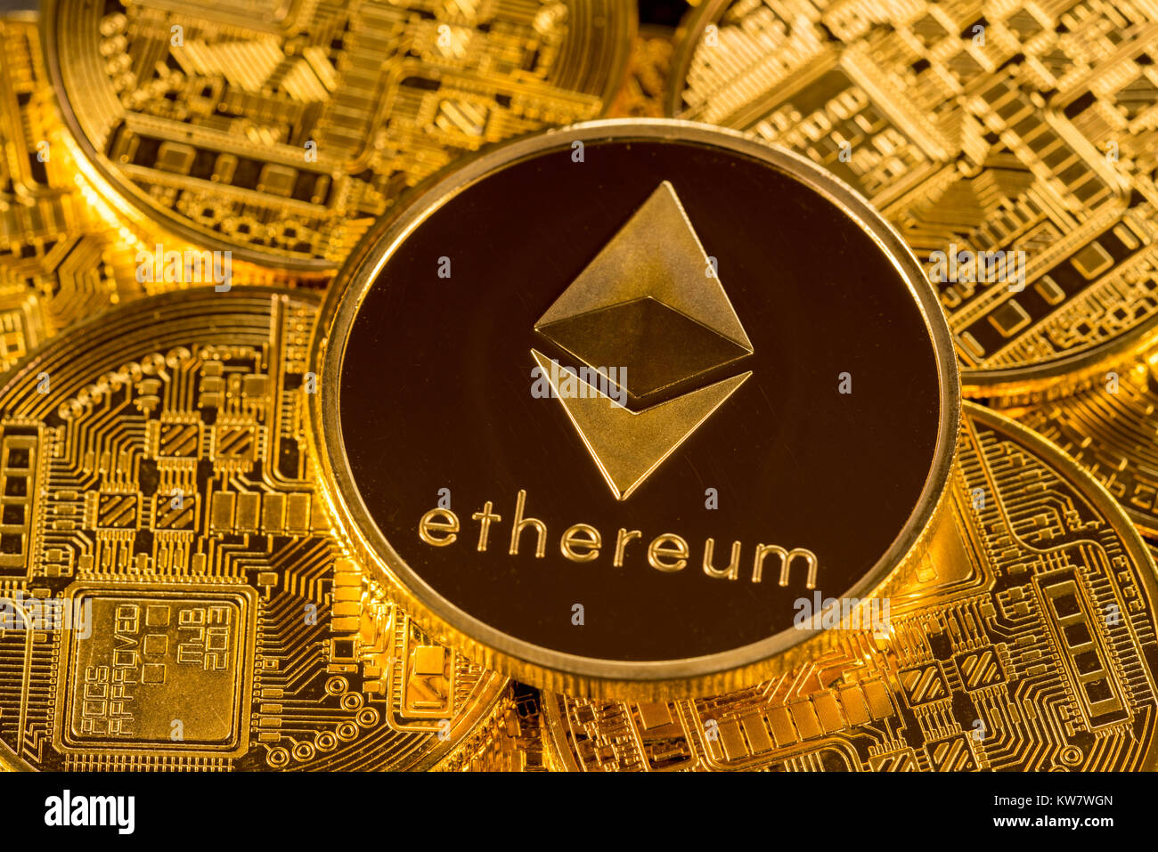 Stack of Ether coins with gold background Stock Photo - Alamy