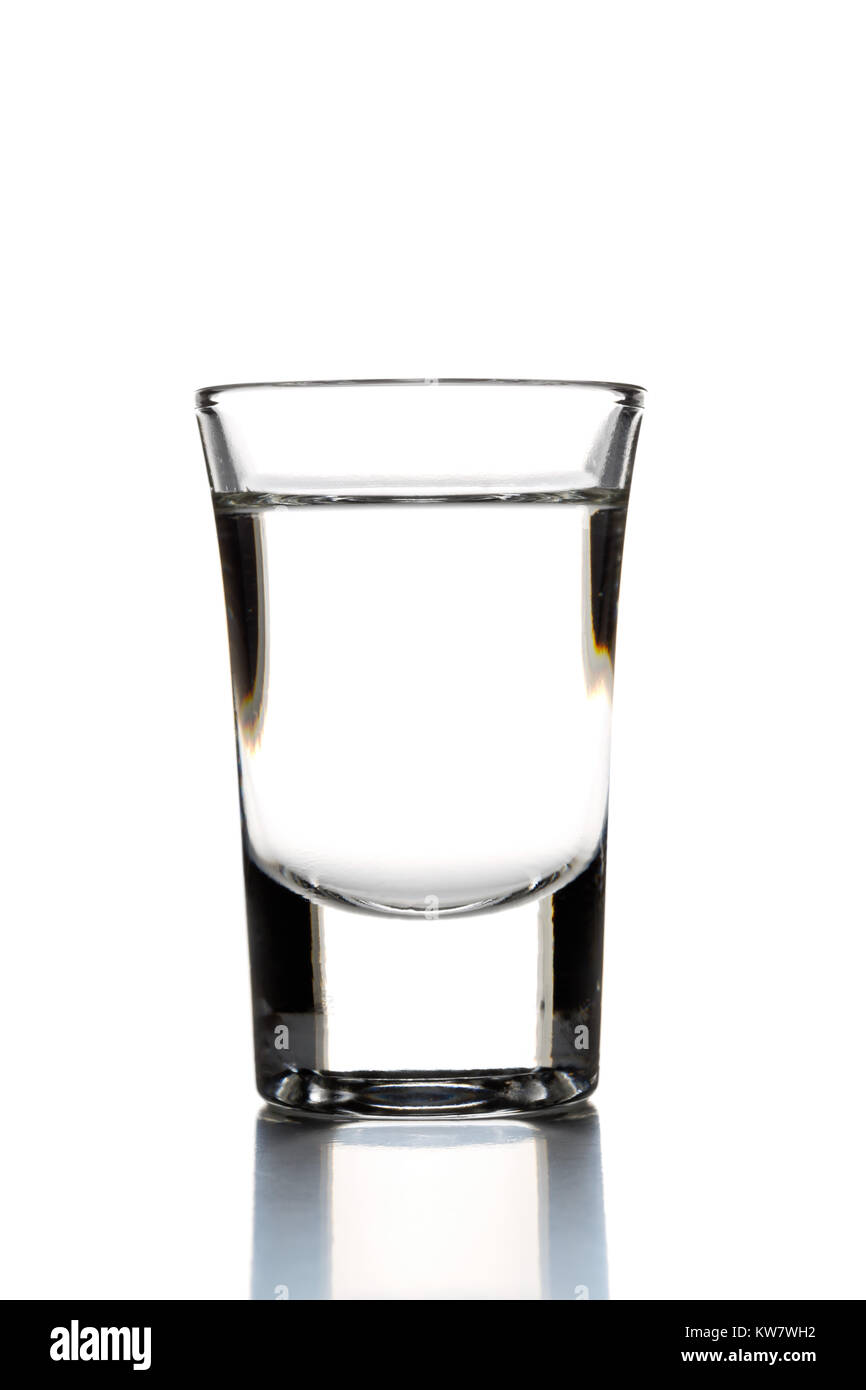 German hard liquor Korn Schnapps in shot glass over white background ...