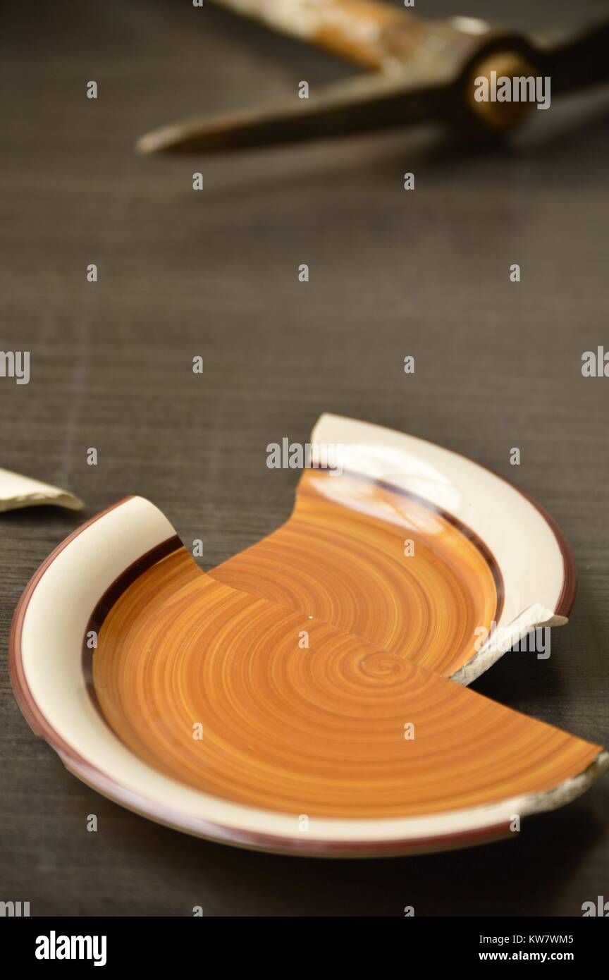 Broken dish and pick tool Stock Photo - Alamy