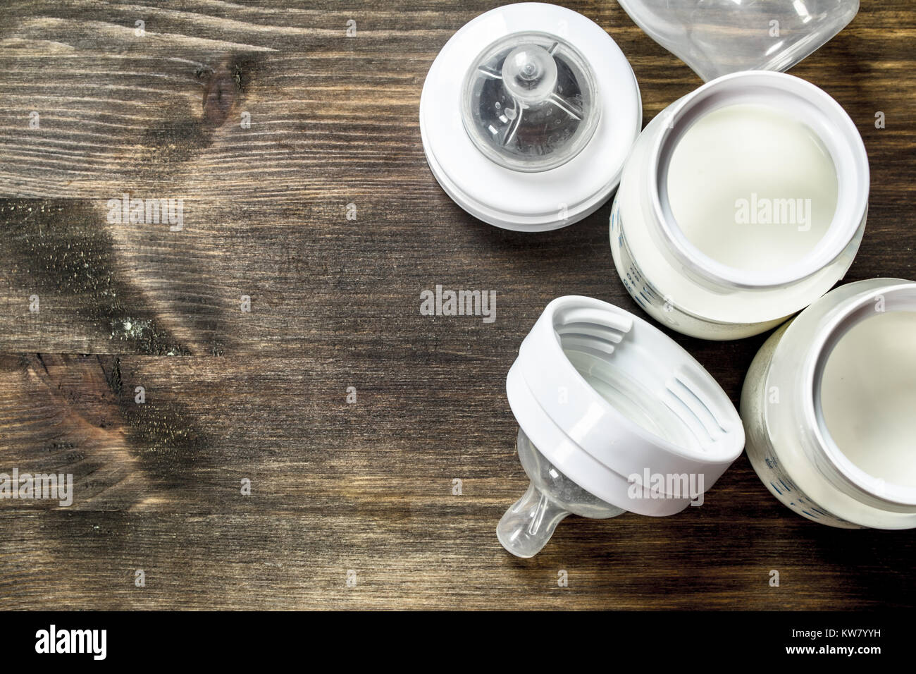 Baby food. Baby milk in small bottles. On a wooden table Stock Photo ...