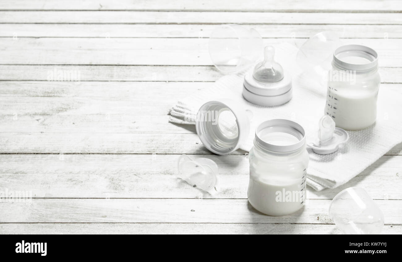Baby food. Baby milk in small bottle. On a white wooden table Stock ...