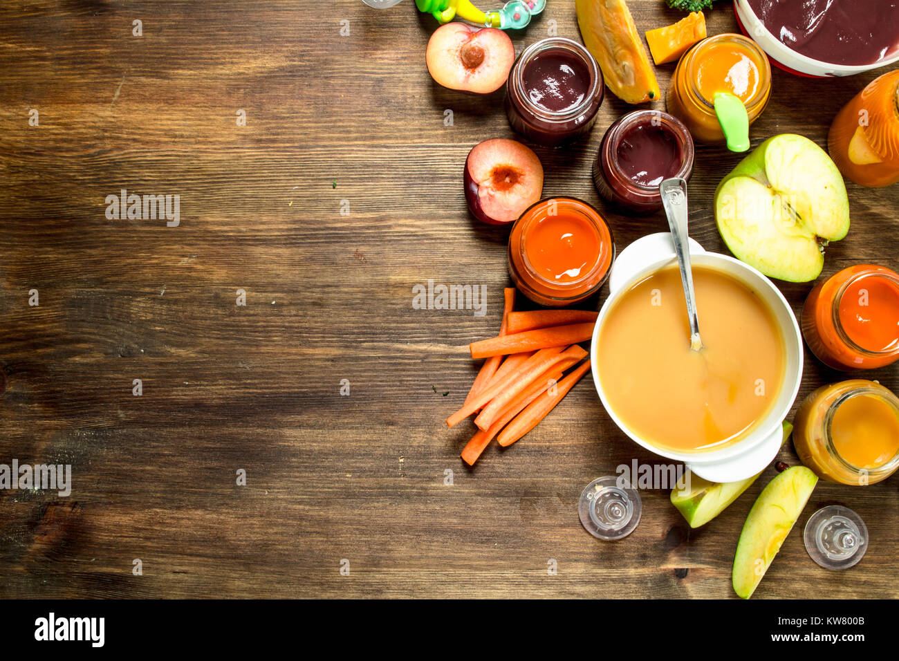 Baby food. Various purees of fruits and vegetables. On a wooden ...