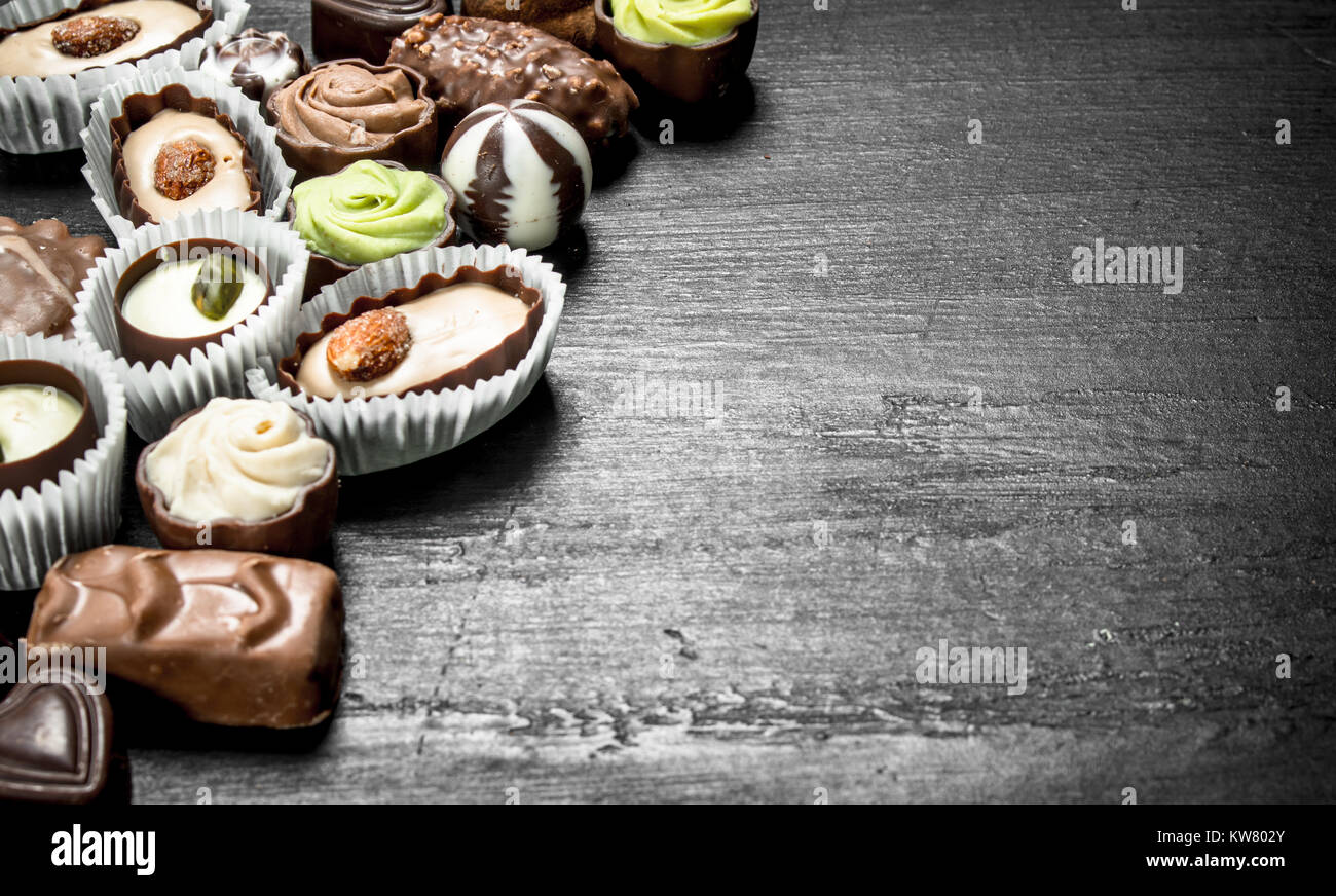 Chocolate sweet candies. On the black chalkboard Stock Photo - Alamy