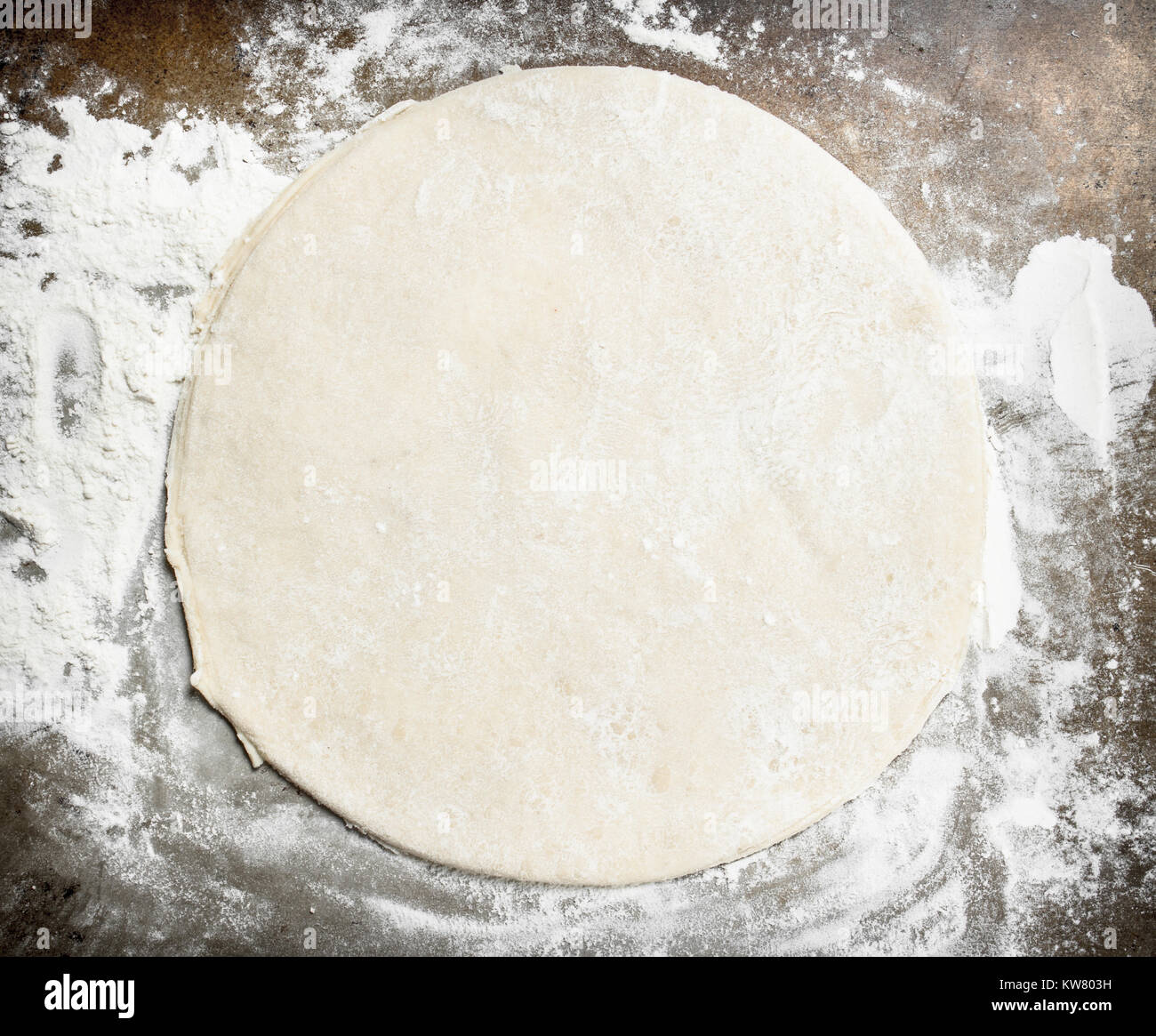 Roll out dough for pizza. On a rustic background Stock Photo - Alamy