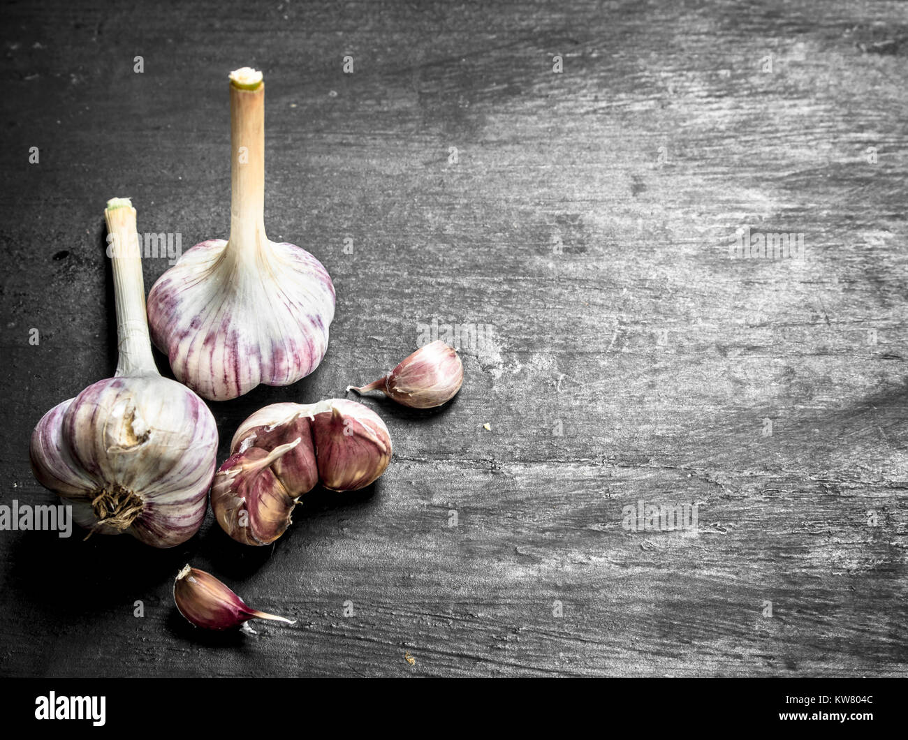 Fresh spicy garlic. On a black chalkboard Stock Photo - Alamy