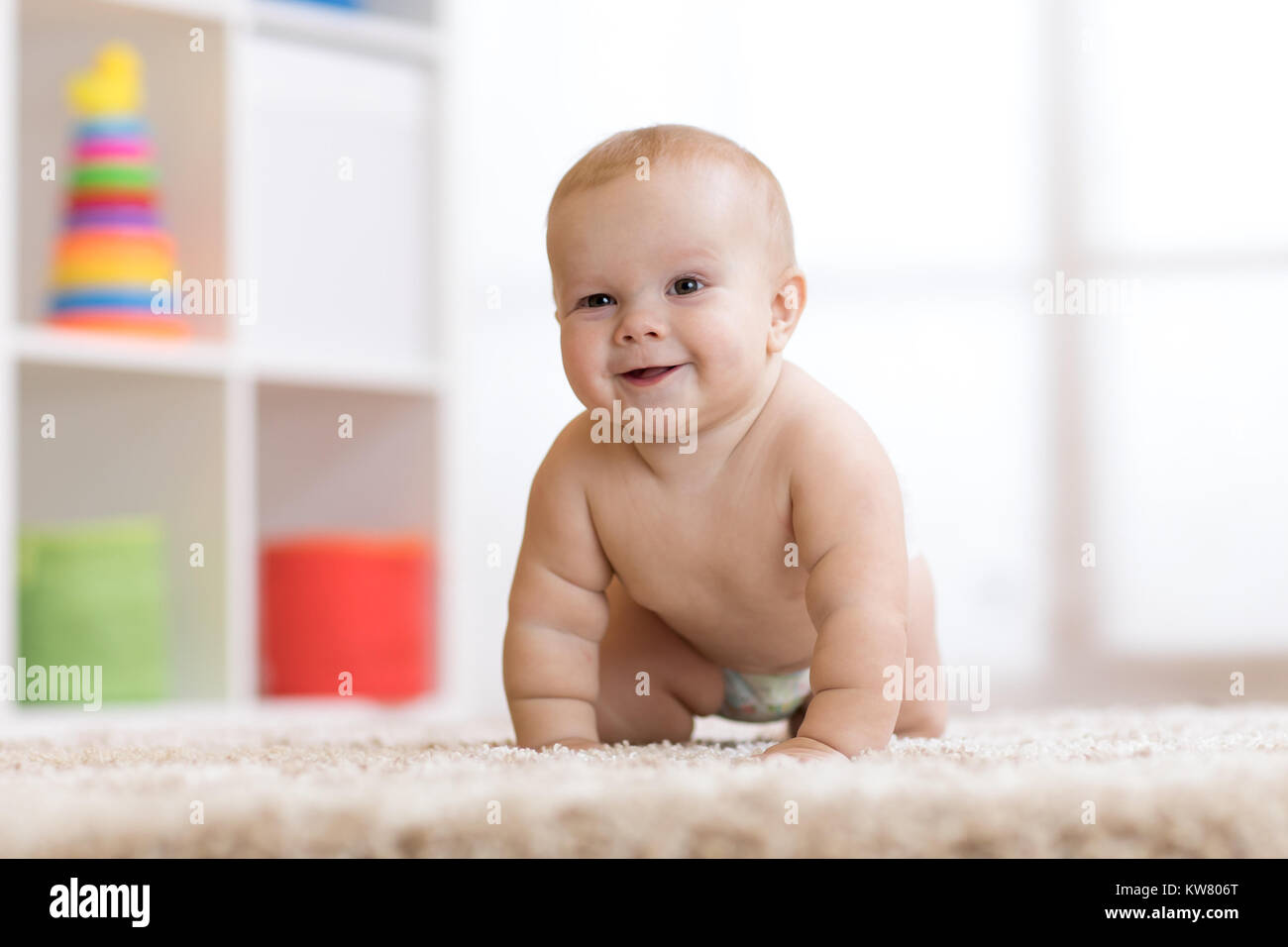 pretty crawling baby weared in diaper Stock Photo - Alamy