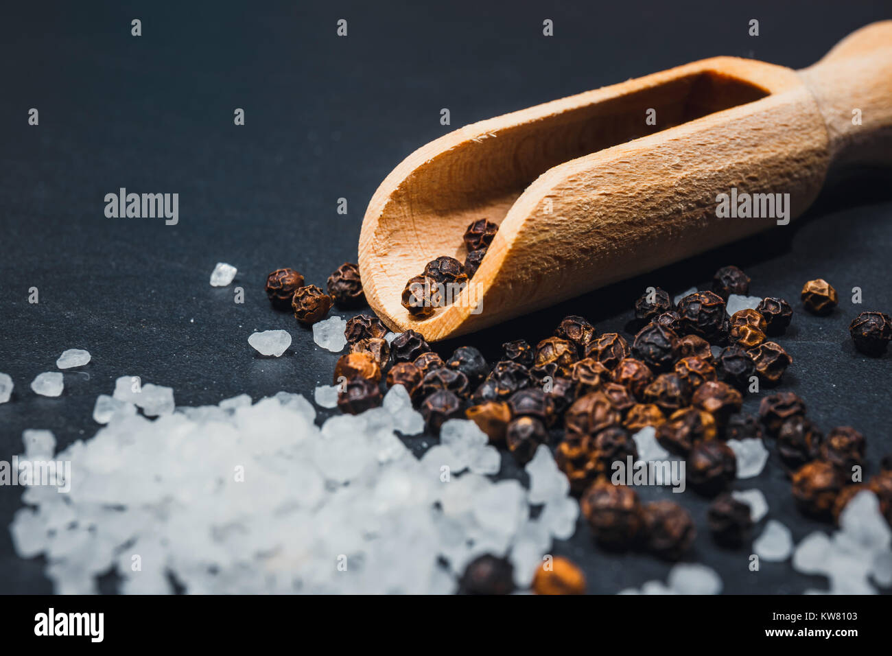 Black pepper and salt on rustic stone background. Overhead view food ...