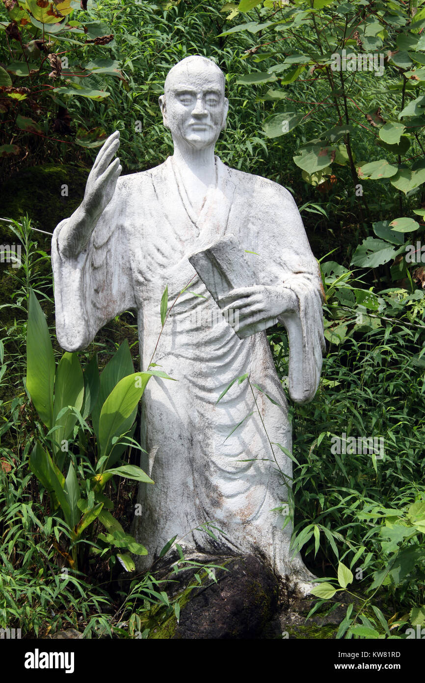 Statue of chinese buddhist holy man and tree Stock Photo - Alamy