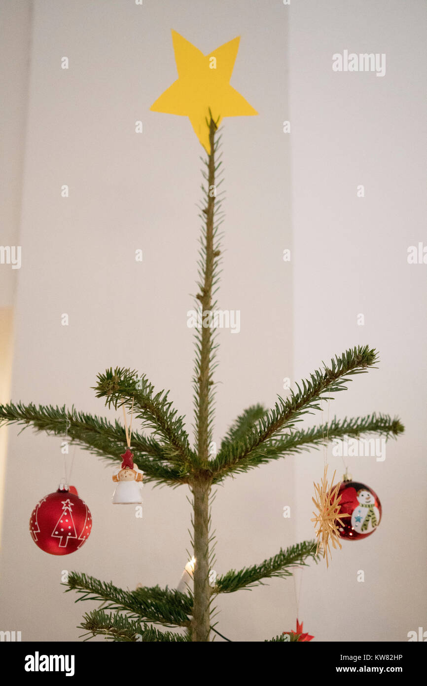 Star on the top of a Christmas tree with two Christmas balls on the ...