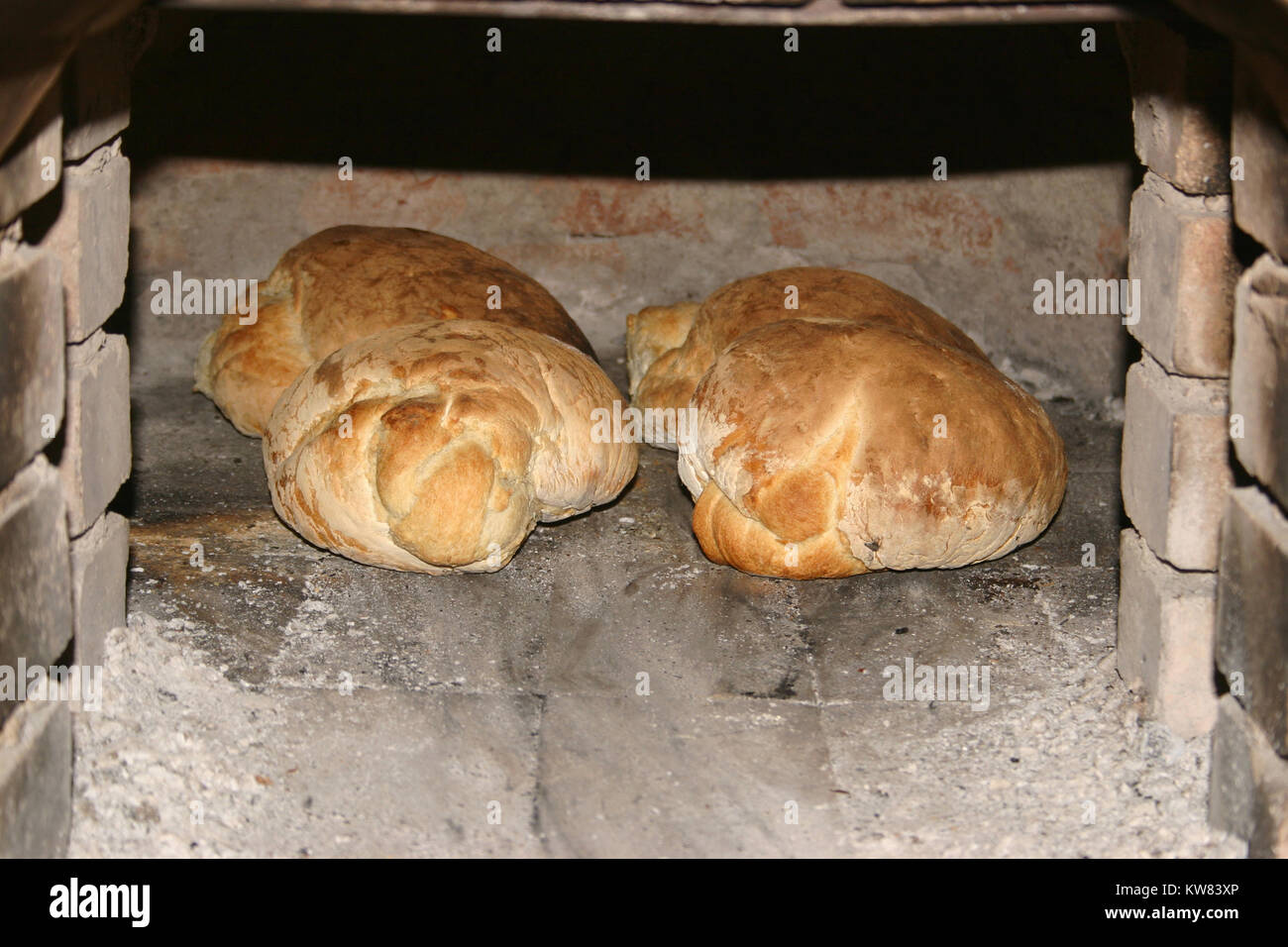 Baking loaves of bread in traditional brick oven Stock Photo - Alamy