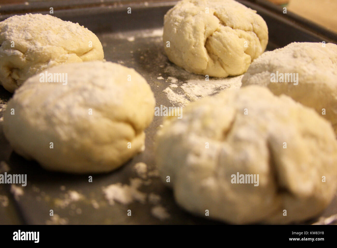 Little bread dough rolls ready to be baked Stock Photo - Alamy