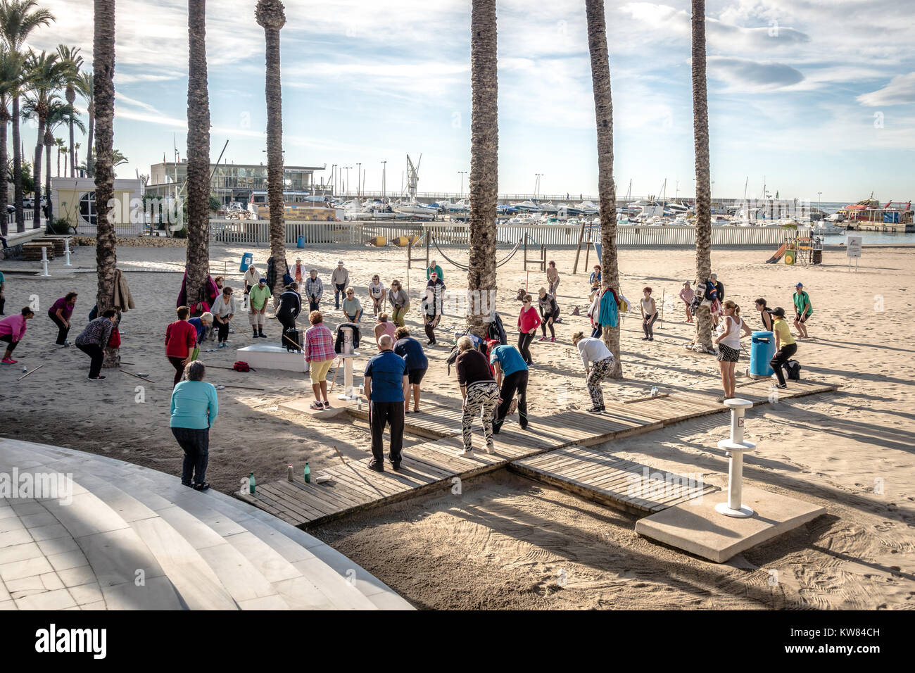 Elderly people doing exercises on the beach. Healthy lifestyle, active ...