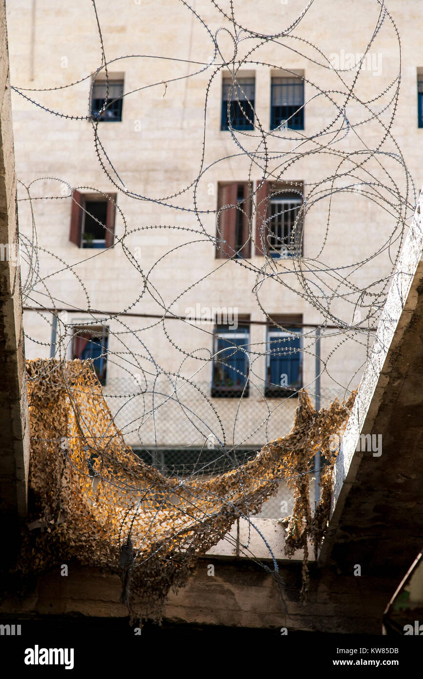 Hebron, Palestine, November 7 2010. Net and barbed wire barier ...
