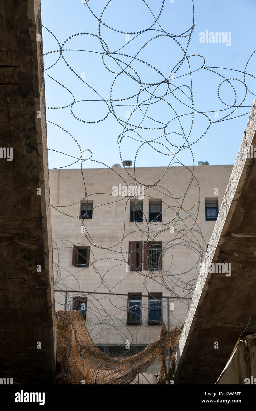 Hebron, Palestine, November 7 2010. Net and barbed wire barier ...