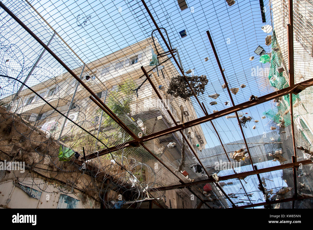 Hebron, Palestine, November 7 2010. Net and barbed wire barrier filled ...