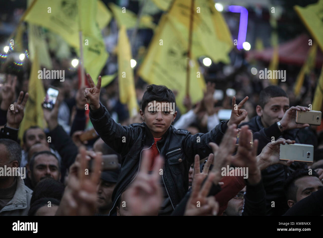 Supporters of the Palestinian national movement Fatah wave its flags ...