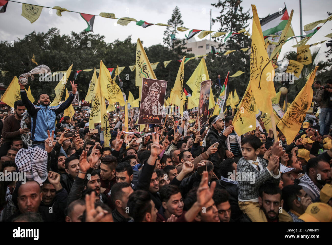 Supporters of the Palestinian national movement Fatah wave its flags ...