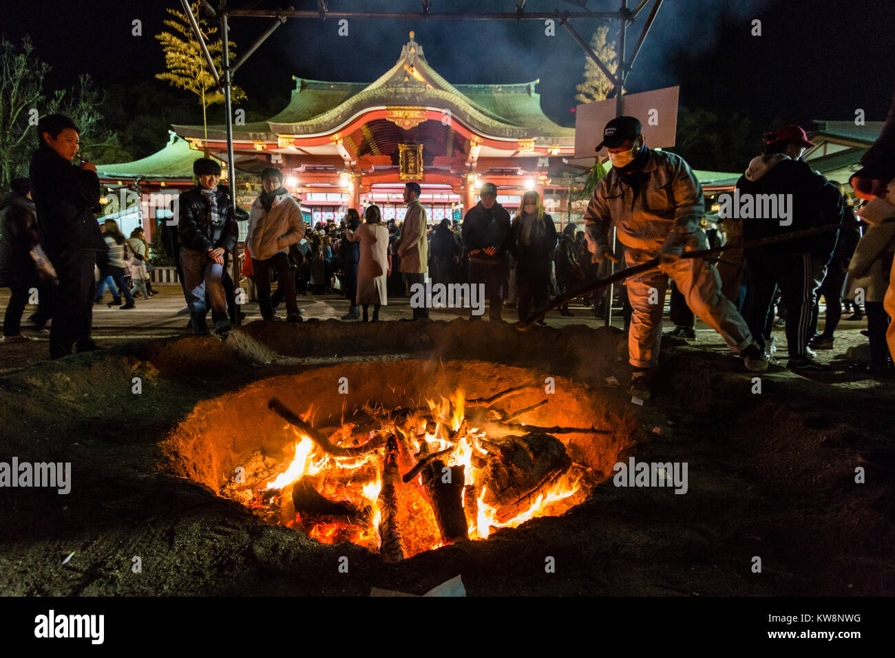 Japan, Nishinomiya shrine. New year, night time. People around bonfire ...
