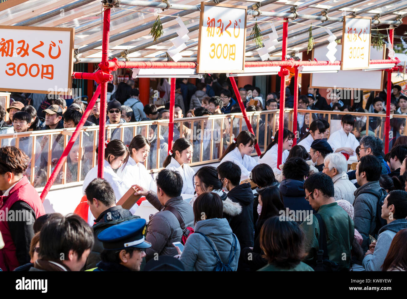 Japan, Kobe, Ikuta shrine. New Year. People buying omikuji, paper ...