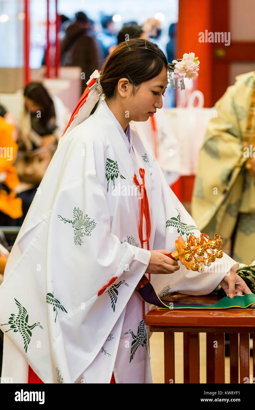 Japan, Kobe, Ikuta shrine. Portrait of a Miko, a shrine maiden, wearing ...