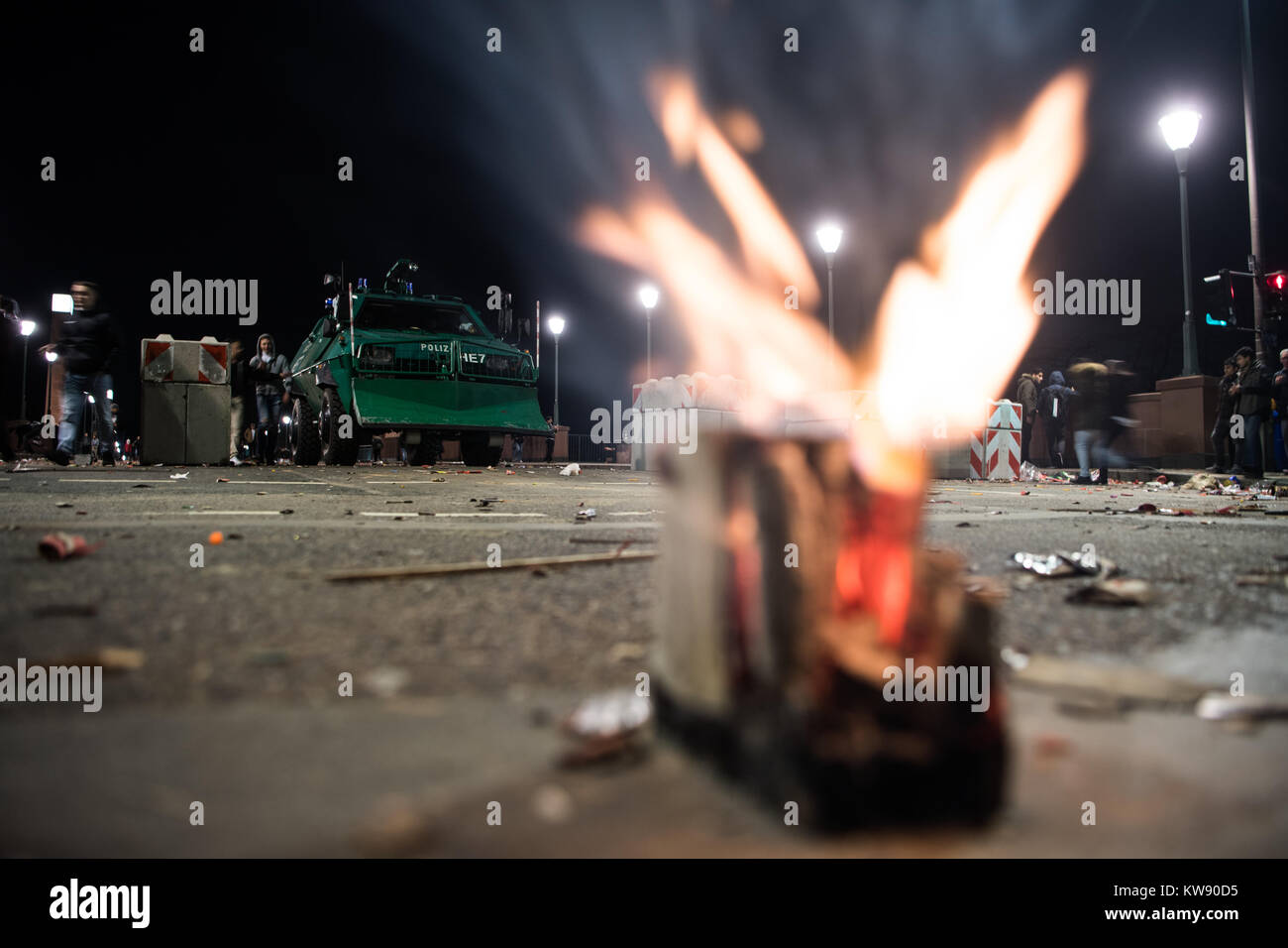 A burned out fireworks burns next to an armoured police wagon in ...
