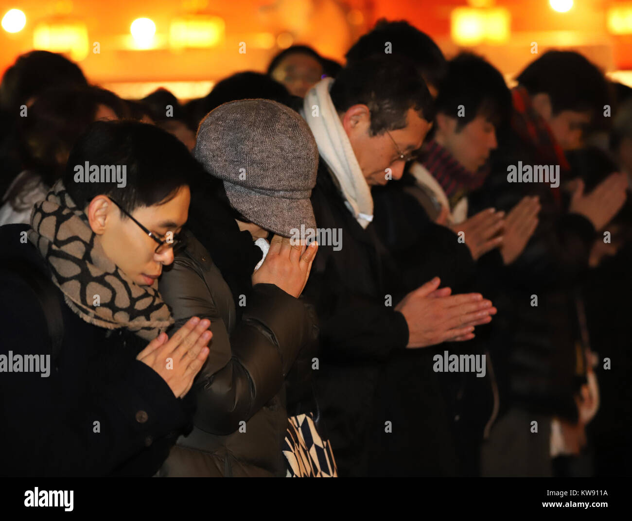 Tokyo, Japan. 1st Jan, 2018. Japanese worshippers pray as they ...