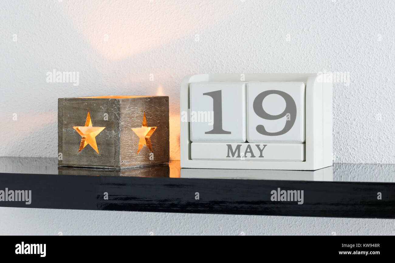 White block calendar present date 19 and month May on white wall ...