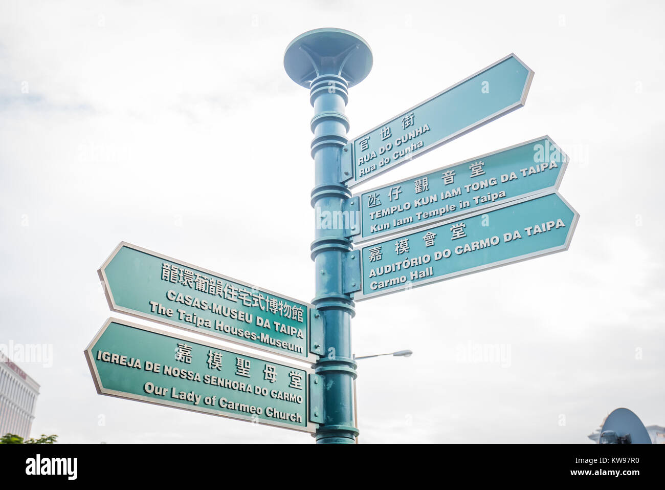 macau green pole tourist direction sign Stock Photo - Alamy