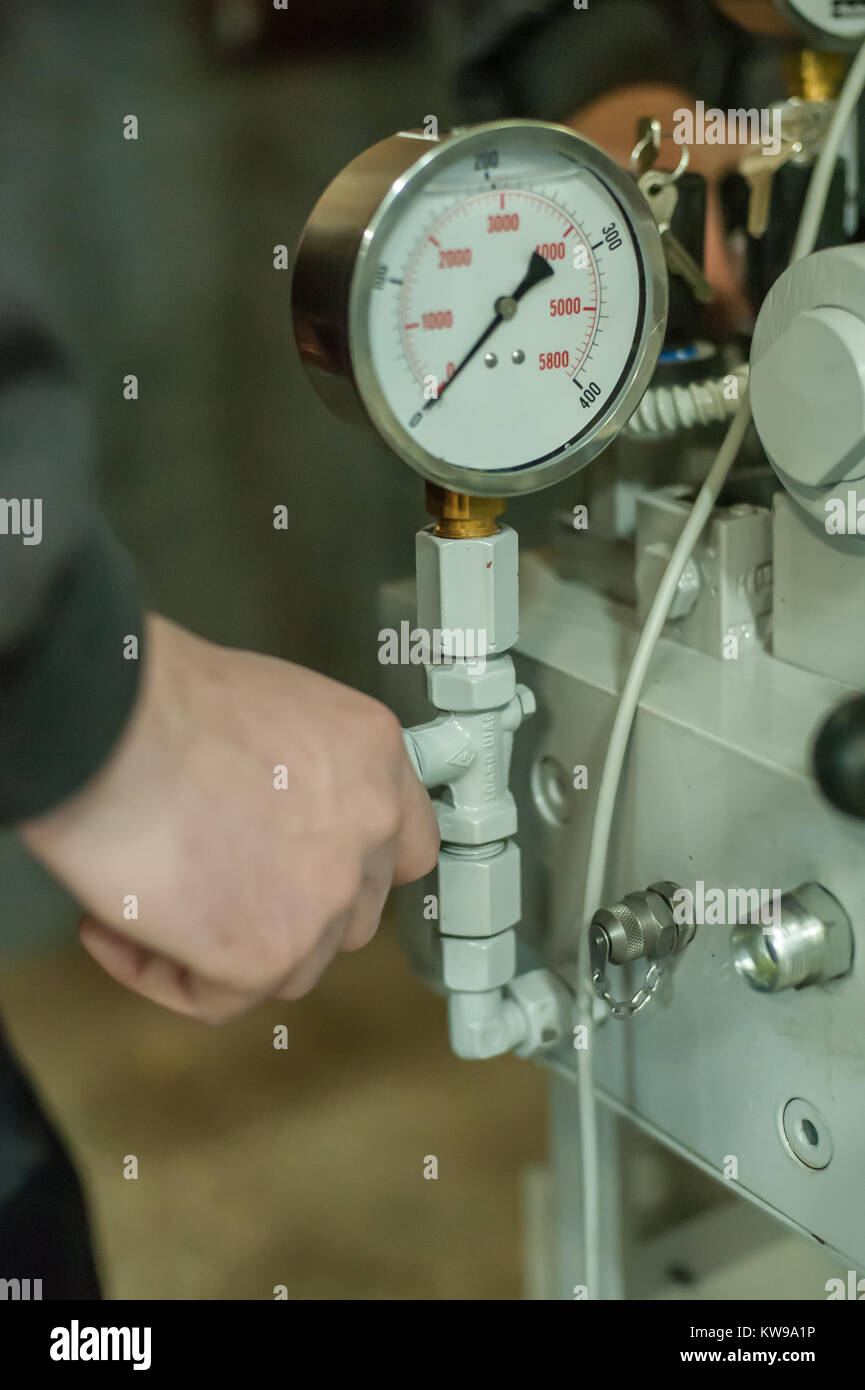 Industrial machinery mechanics and factory worker adjusts industry ...