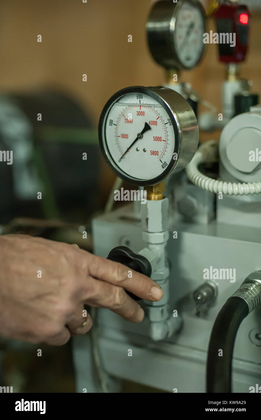 Industrial machinery mechanics and factory worker adjusts industry ...