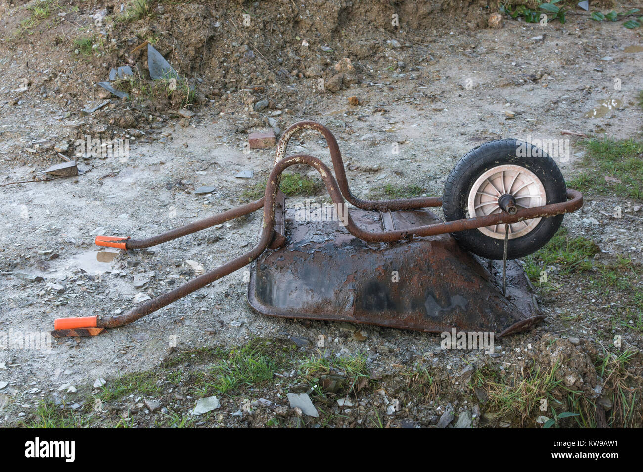 Upturned wheelbarrow on small construction site - for downturn in the ...