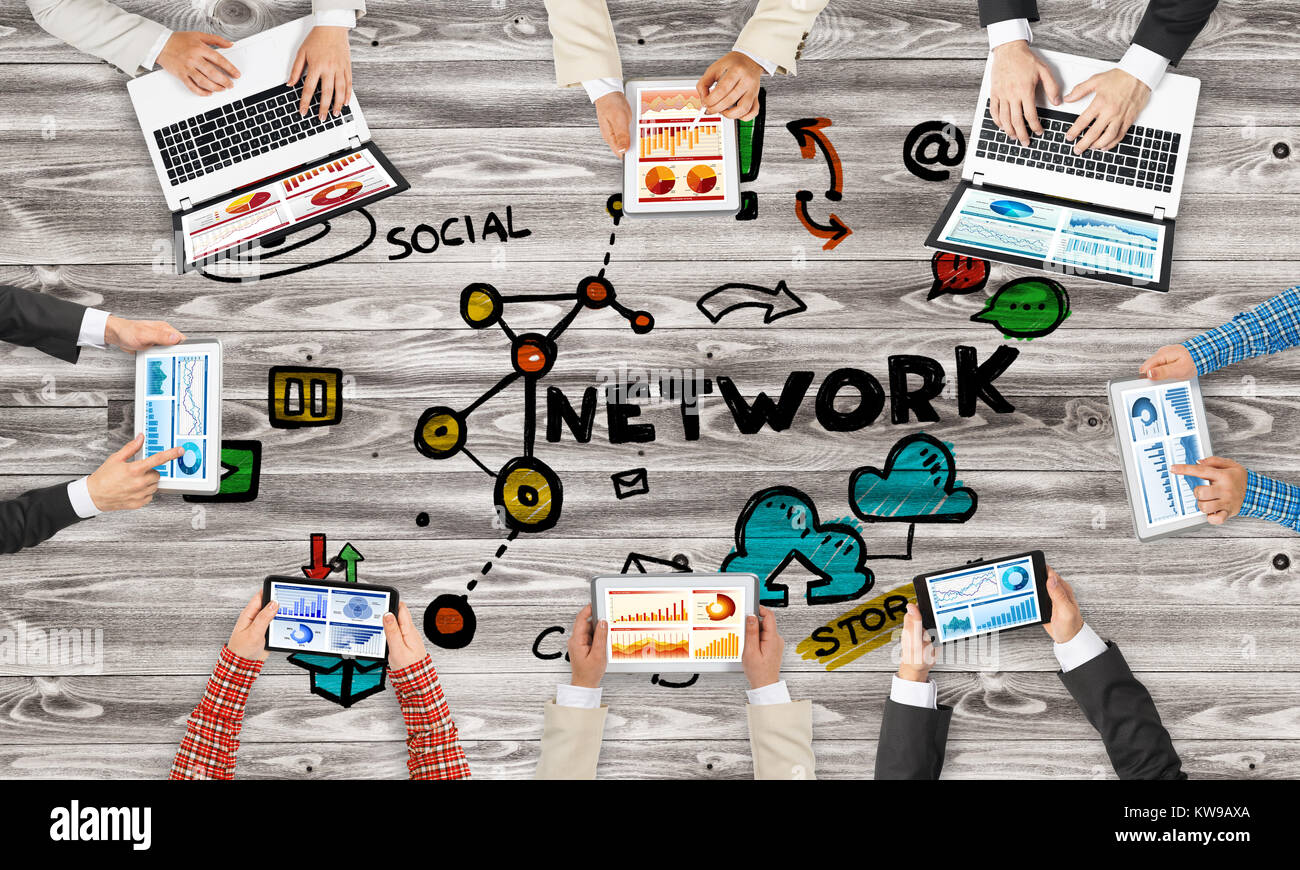 Group of people with devices in hands working together as symbol of ...
