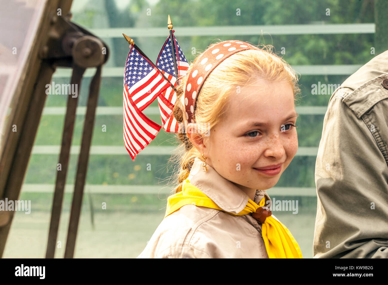 Little Scout girl with us flags in her hair, Celebrations of the ...