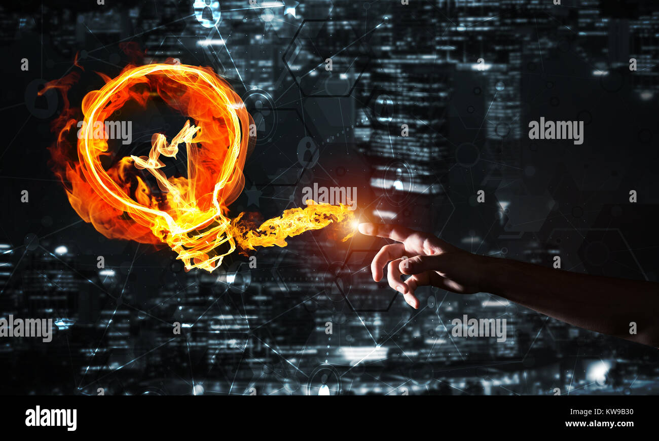 glowing fire light bulb icon on night city background Stock Photo - Alamy