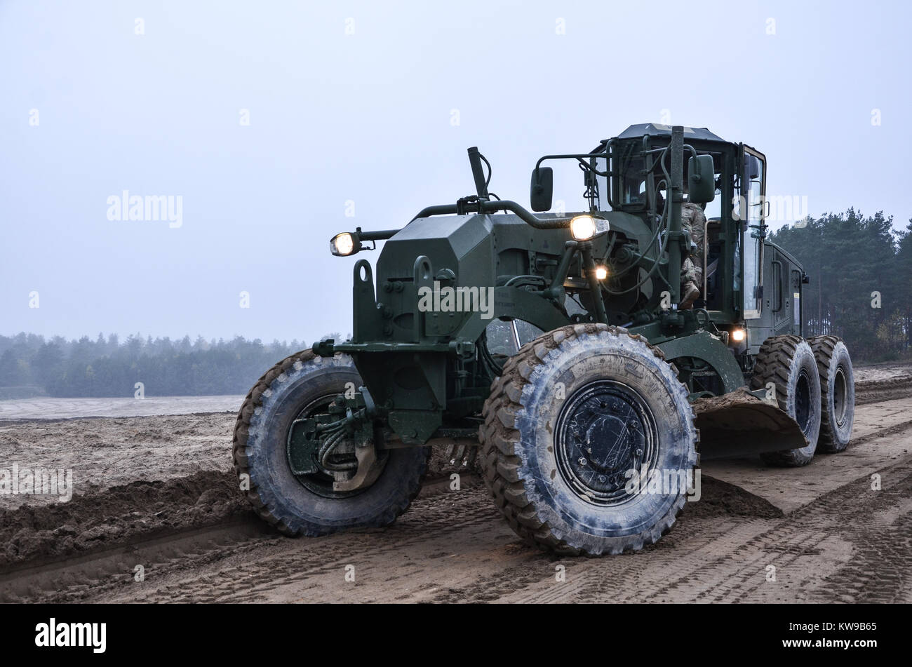 An engineer from the 173rd Airborne Brigade uses cuts a grade for an ...