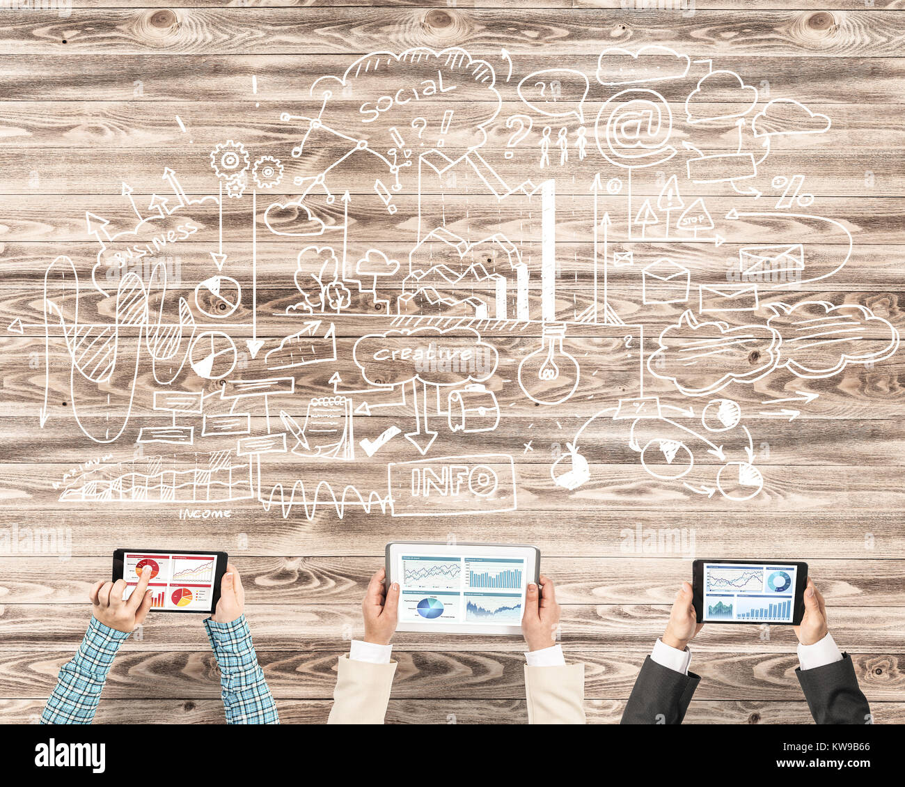 Group of three people with devices in hands working together as symbol ...