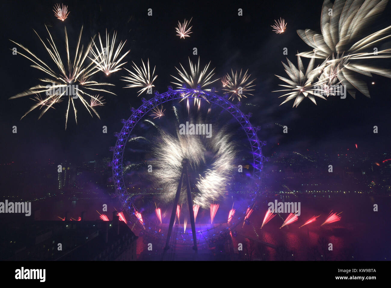Fireworks light up the sky over the London Eye in central London during ...