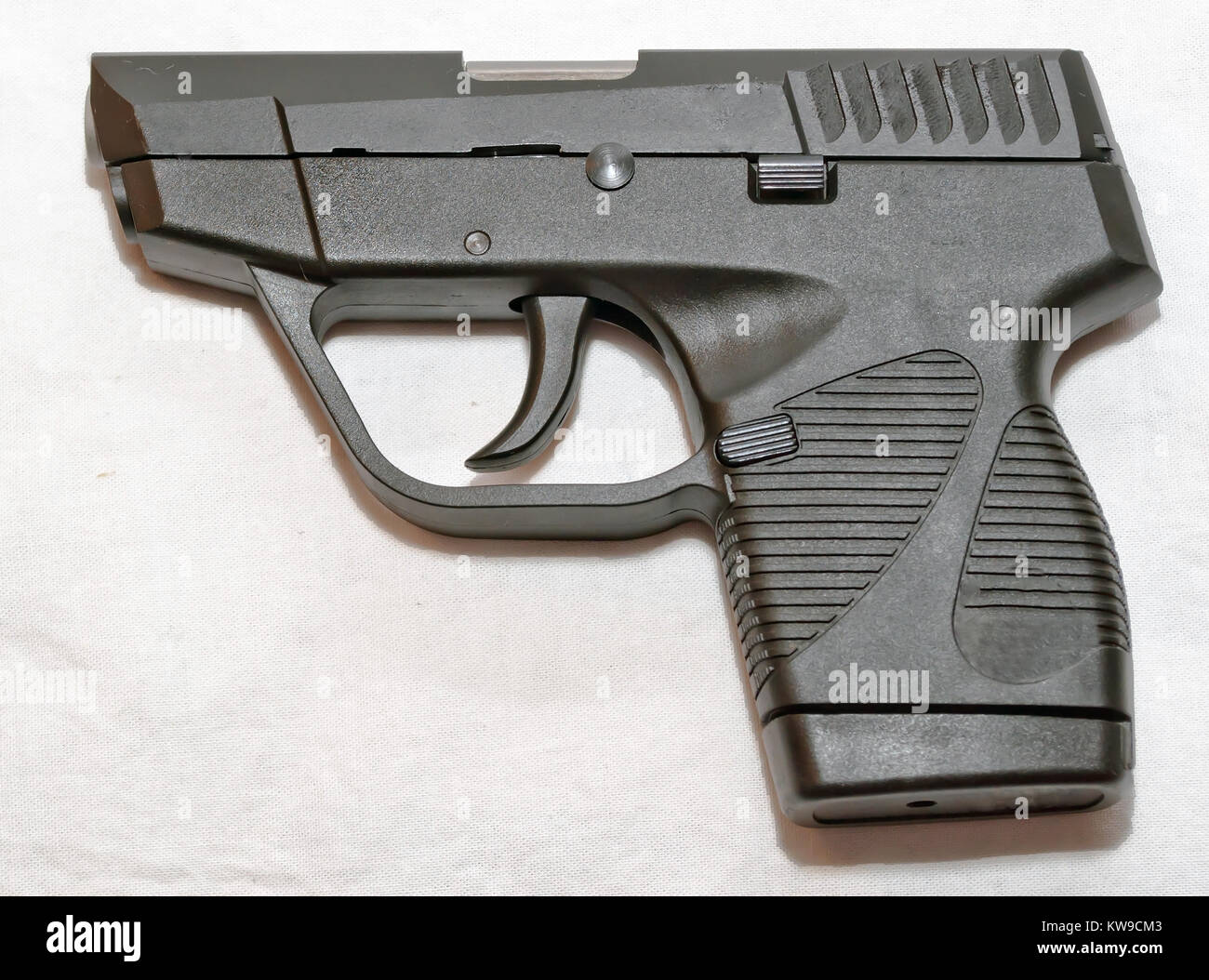 A small caliber black pistol on a white background Stock Photo - Alamy