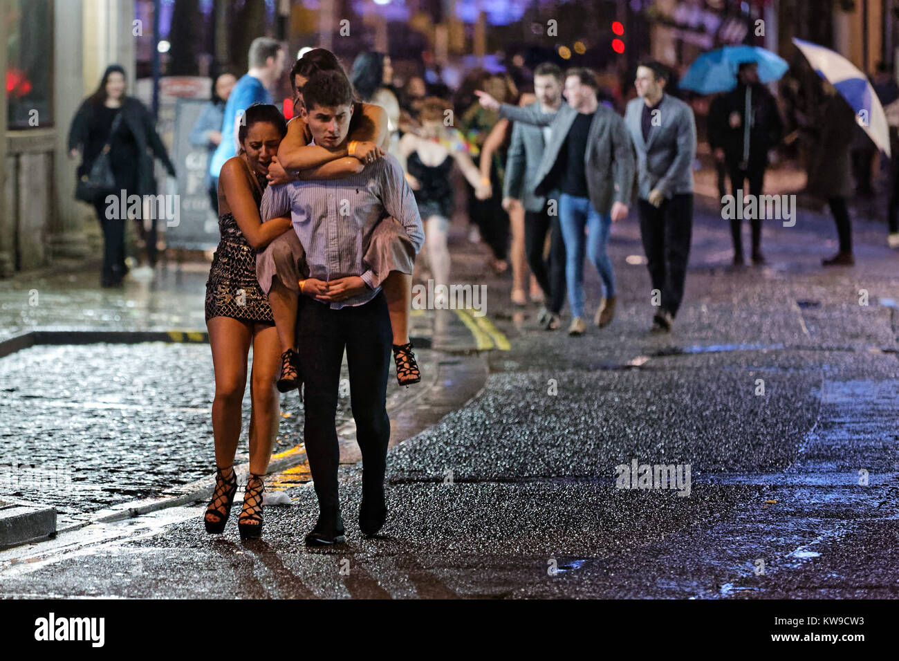 A young woman gets a piggy back ride by a young man Stock Photo - Alamy