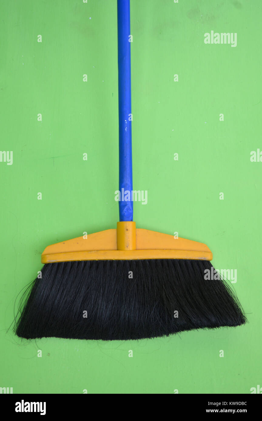 blue broom fibers on green wall Stock Photo - Alamy