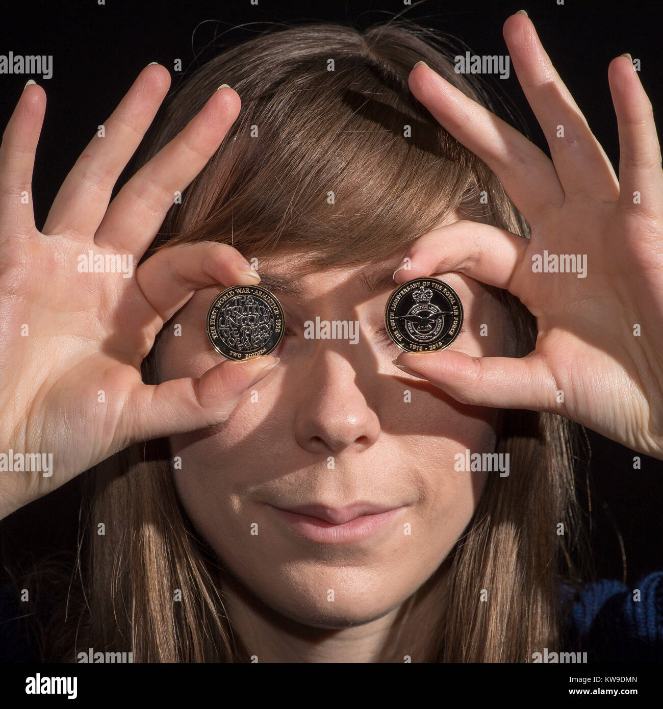 Alex Powell from the Royal Mint, Llantrisant, Wales, holds two new ...