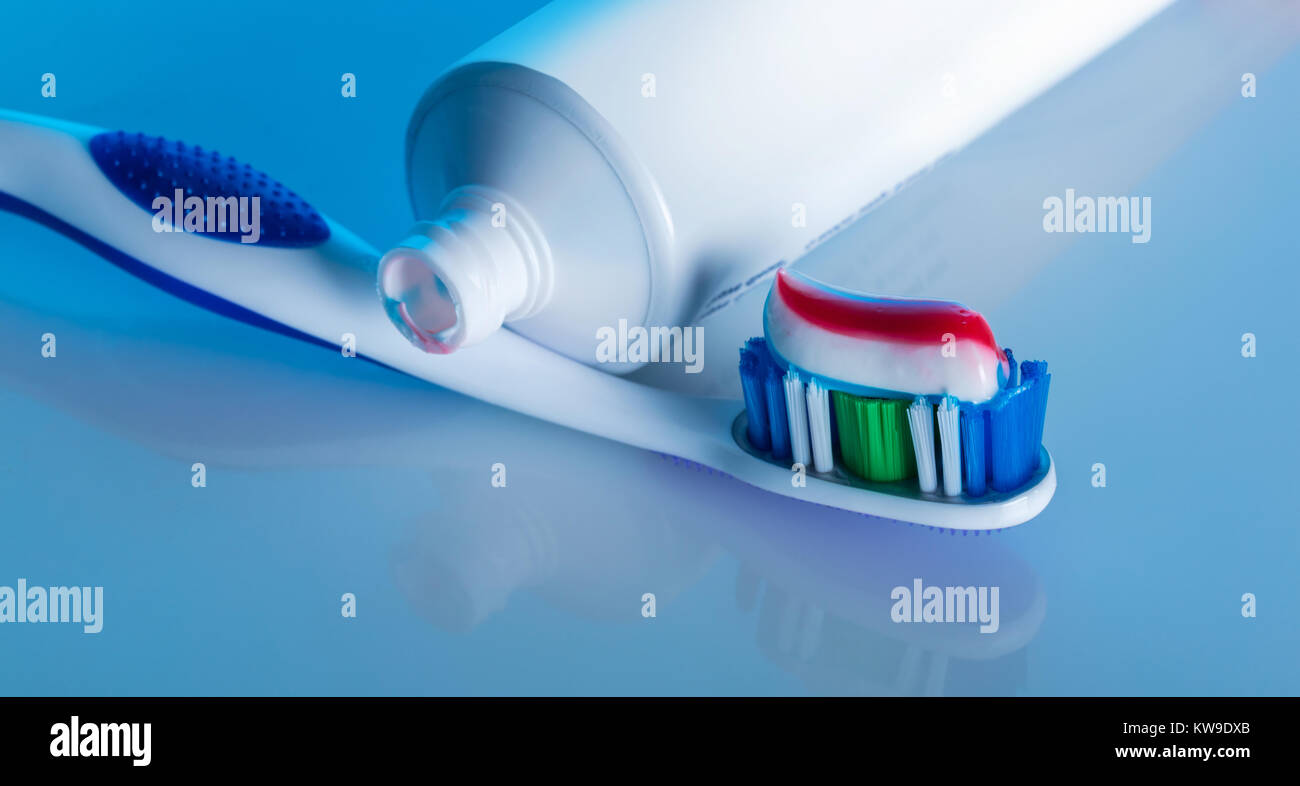 toothbrush with paste on a blue background with reflection Stock Photo ...