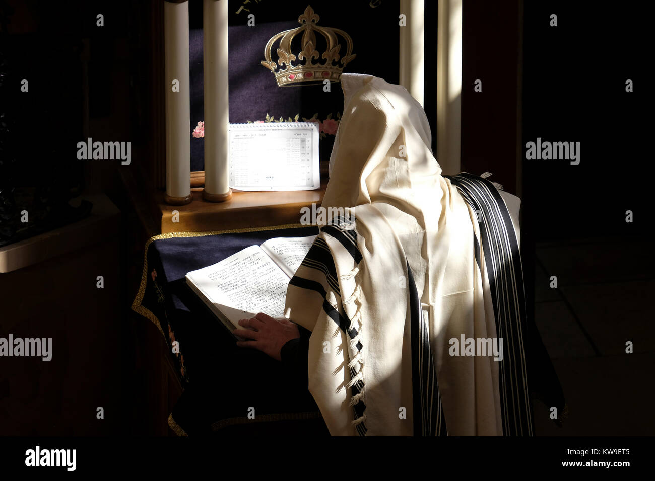 An orthodox Jew wrapped with traditional Talit shawl prays inside the ...